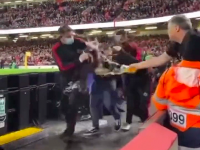Rugby fan drenched with beer after invading pitch during game